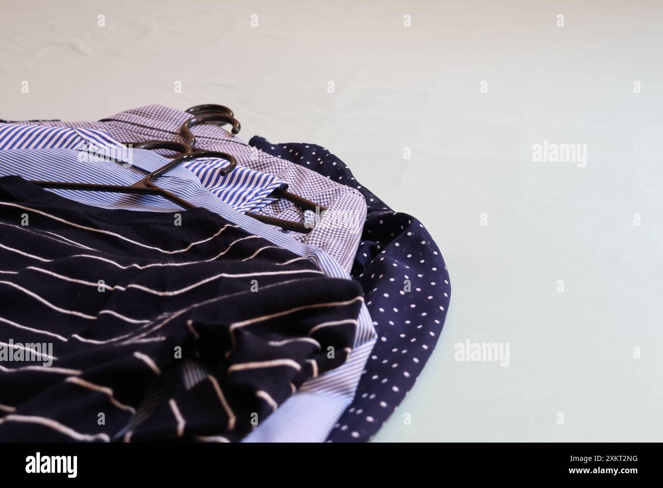 Clothes in shades of blue and different prints still on the hanger ...
