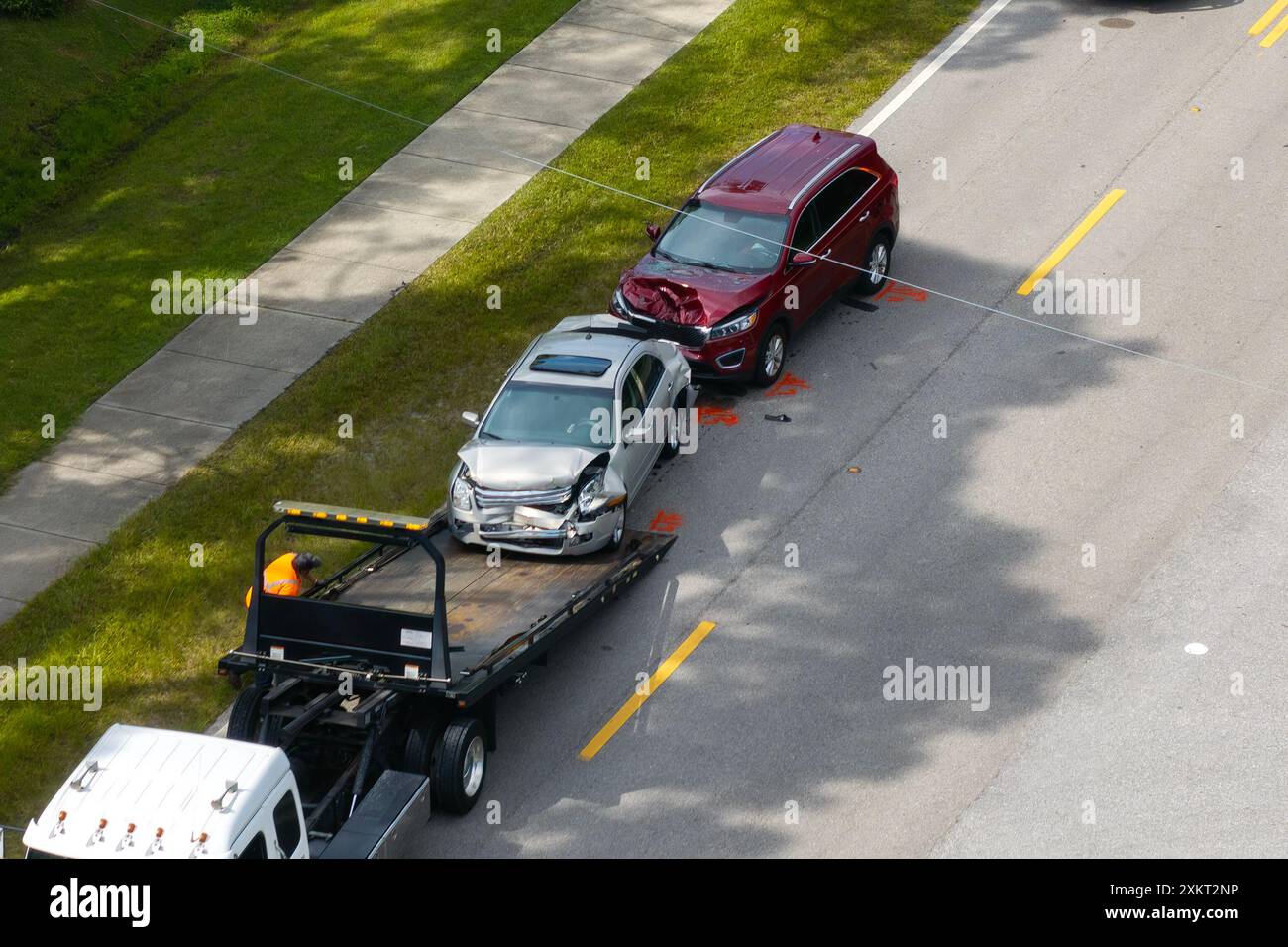 Tow truck loading crashed car on accident site. Emergency services ...