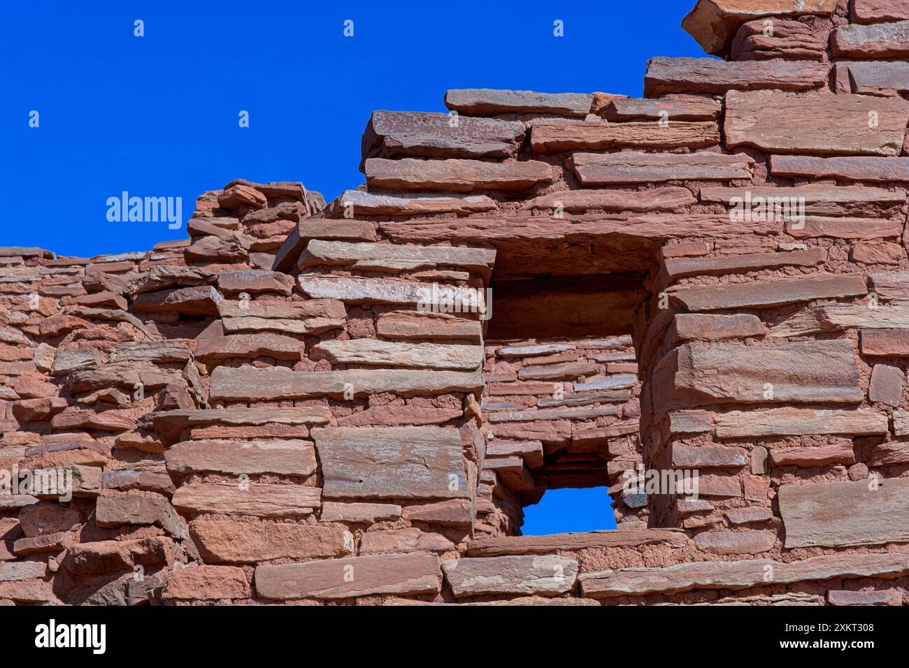 Series of aligned window openings in sandstone block masonry pueblo ...