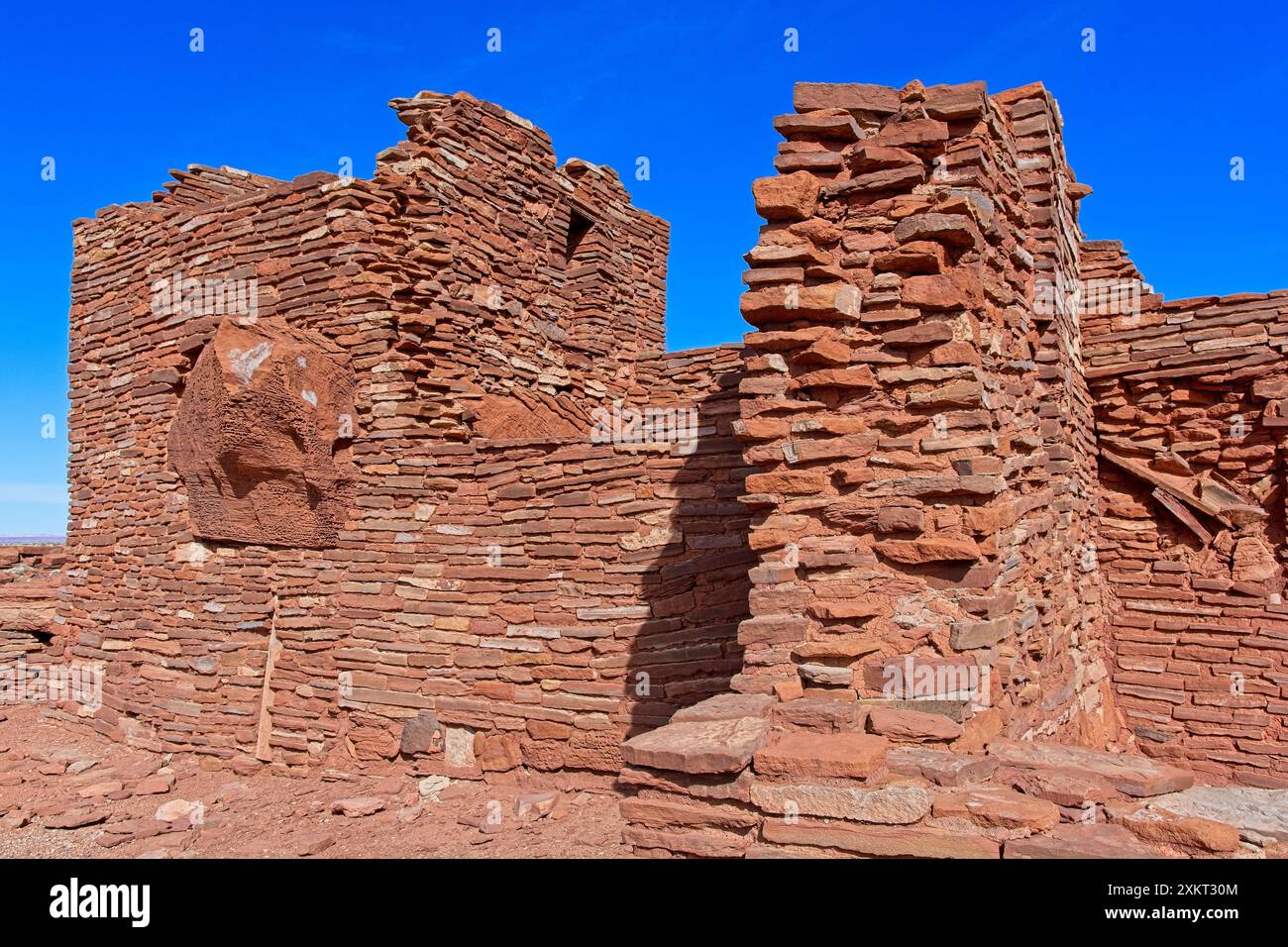 Tall multi-story sandstone block masonry pueblo ruins set against ...