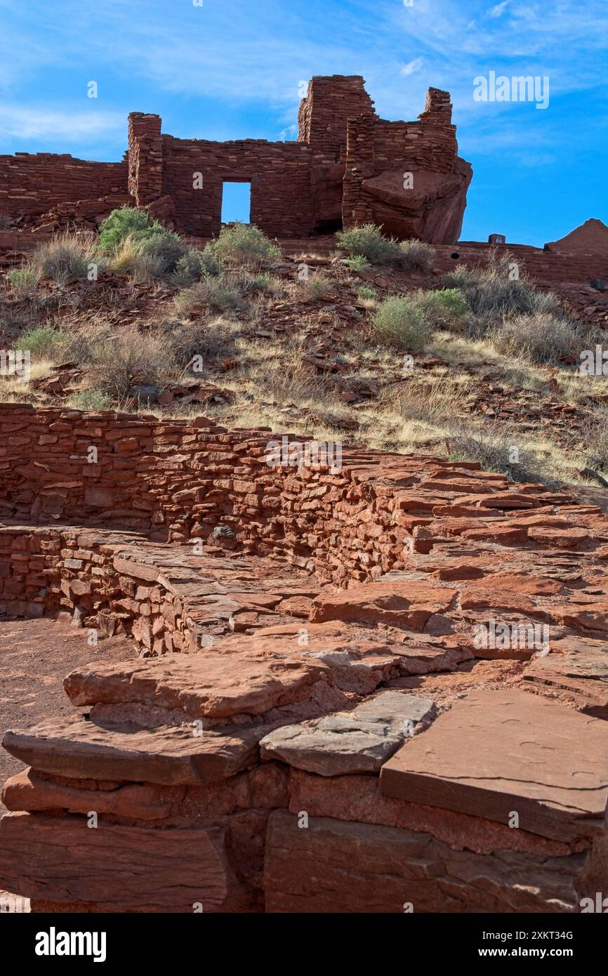 Sandstone block pueblo ruins behind circular masonry walled ...