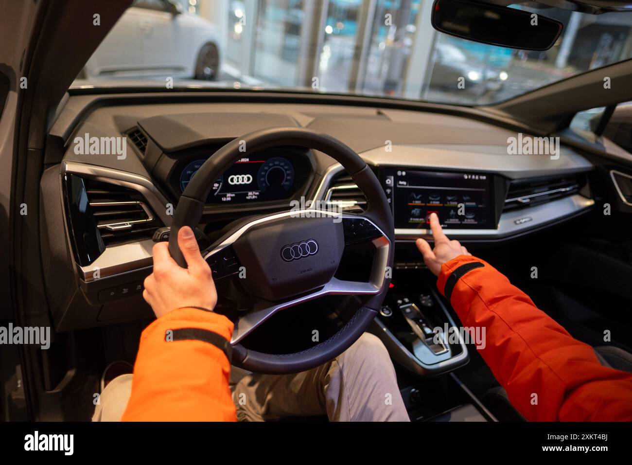 close-up man in car driving electric crossover Audi Q4 e-tron, German ...