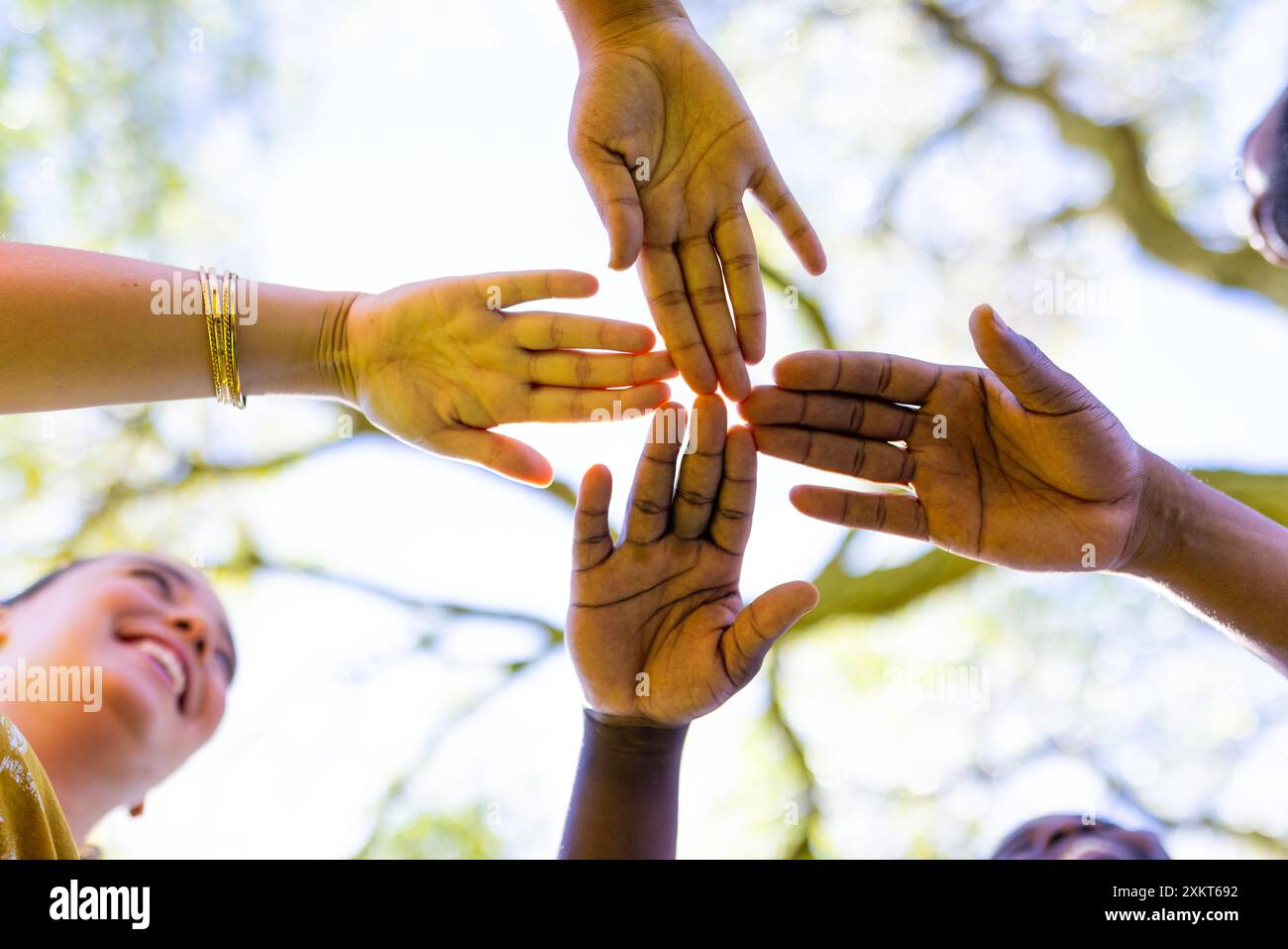 Joining hands together outdoors, friends showing unity and teamwork Stock Photo - Alamy