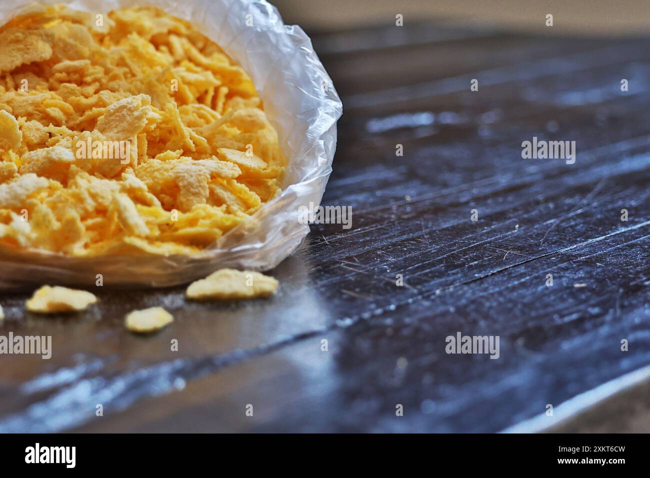 Part of plastic bag with corn flour lying on the table Stock Photo - Alamy