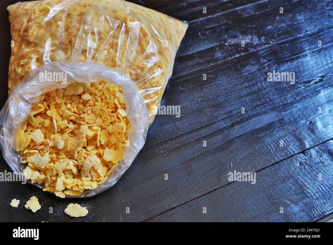 plastic bag with corn flour lying on a dark table photographed from ...