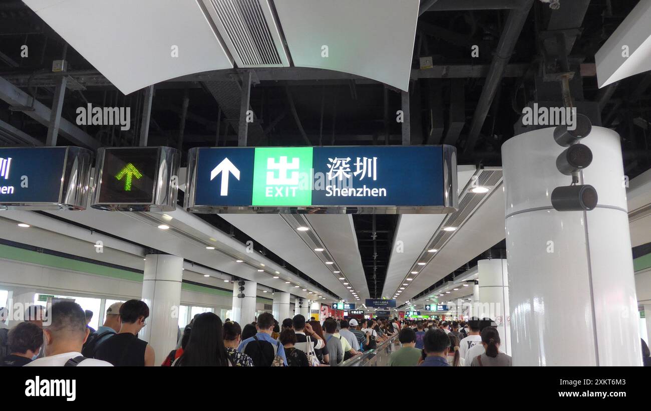 Traveler walk towards Shenzhen in the border control area at MTR Corp ...