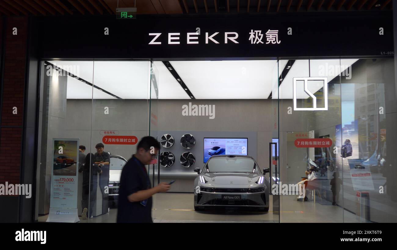 A pedestrian walks past the Chinese publicly listed automobile company ...