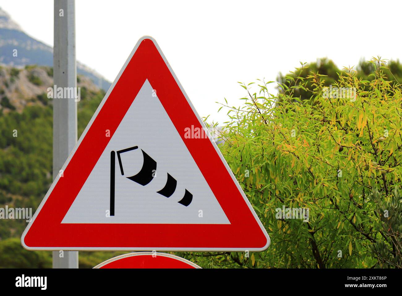 The Crosswind road sign warns of strong crosswinds. It is necessary to ...