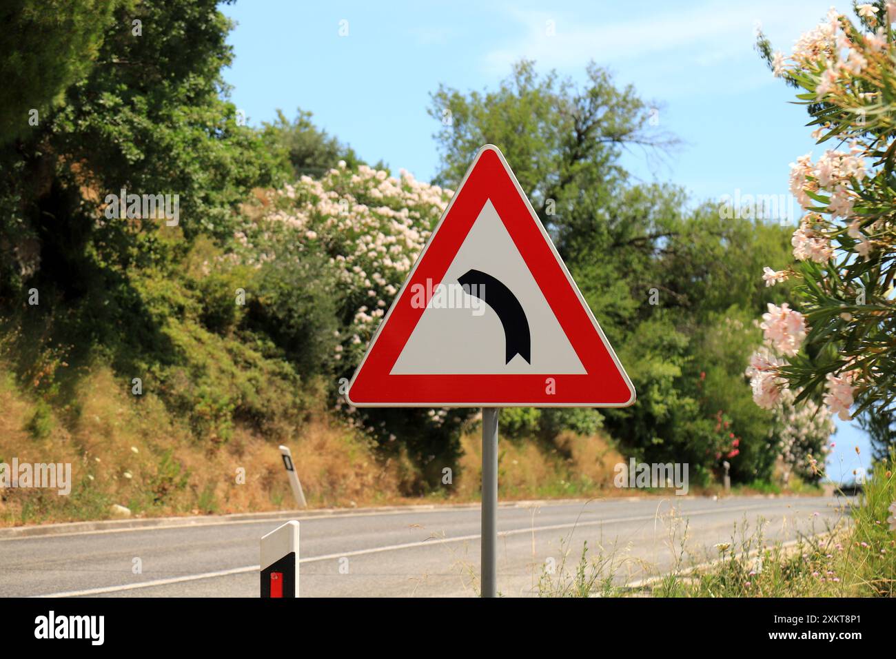Road sign Dangerous left turn on a mountain road in Croatia. Curving ...