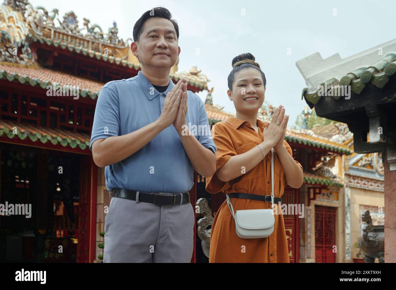 Asian Couple Praying In Ancient Temple Stock Photo - Alamy
