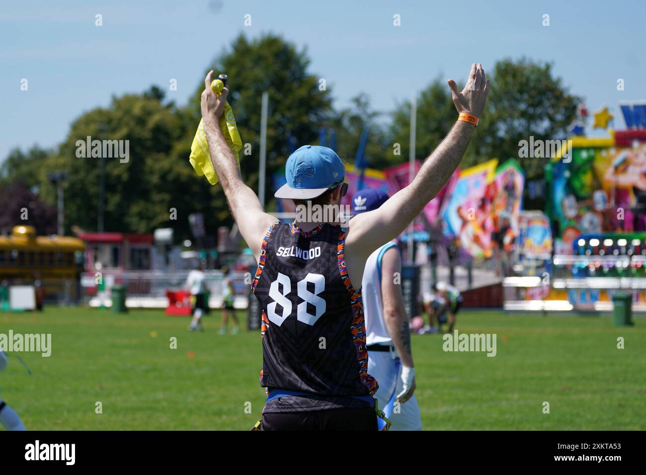 Flag football official signalling a touchdown Stock Photo - Alamy