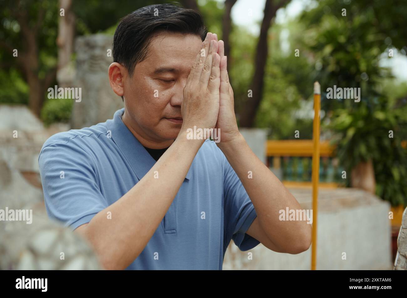 Asian Man Praying In The Temple Stock Photo - Alamy