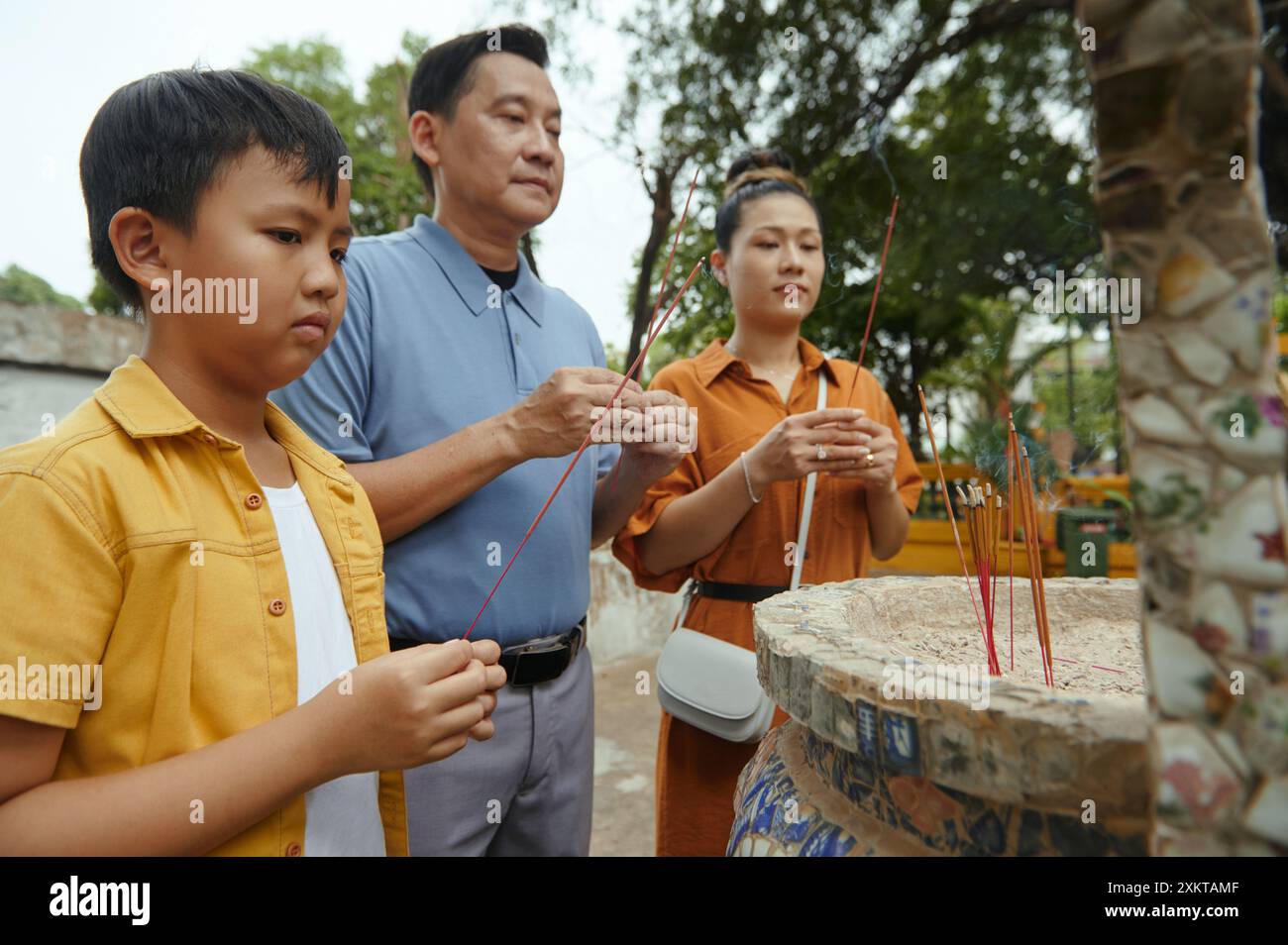 Family Using Aroma Sticks In Pray Stock Photo - Alamy