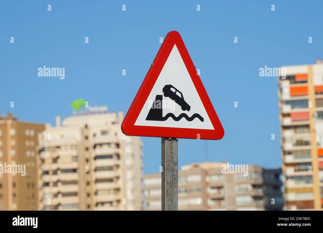 Car falling in water from quay, traffic warning sign in harbour of ...