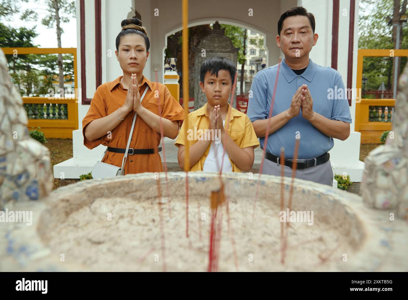 Family Praying In Ancient Temple Stock Photo - Alamy