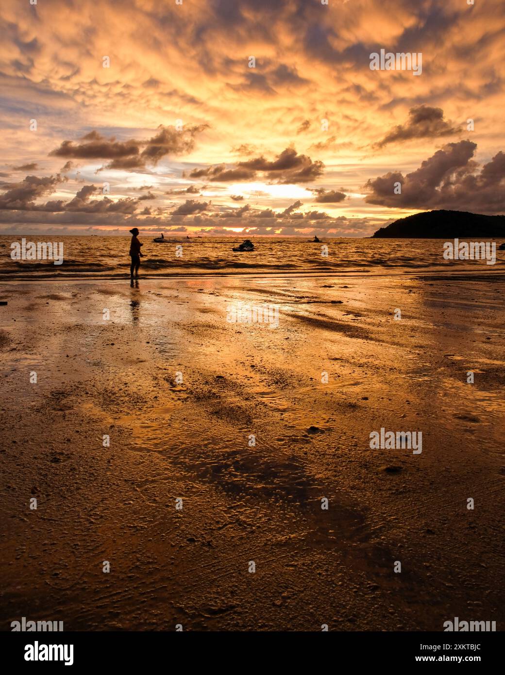A golden sunset over the Andaman Sea at Pantai Cenang beach in Langkawi ...