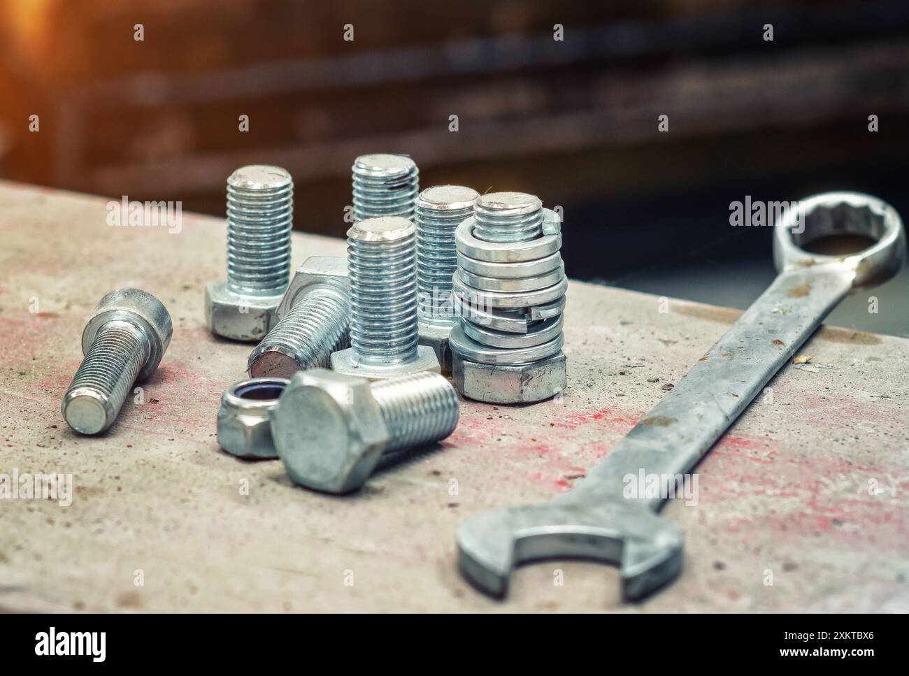 Assortment steel screws close-up. Set of bolts on blurred workshop ...