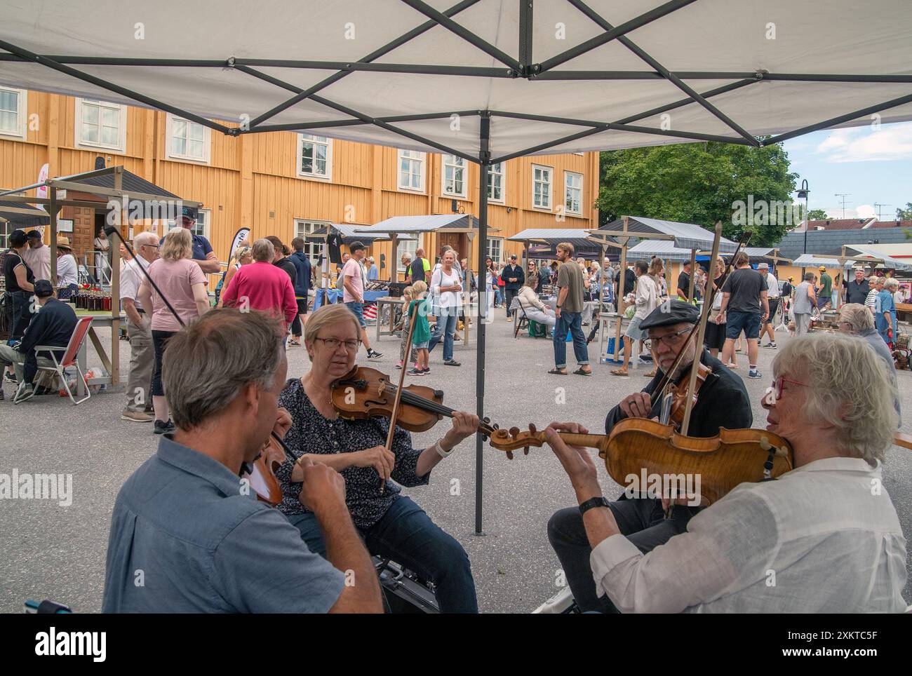 Four musicians are playing during the market days in the village Stock ...