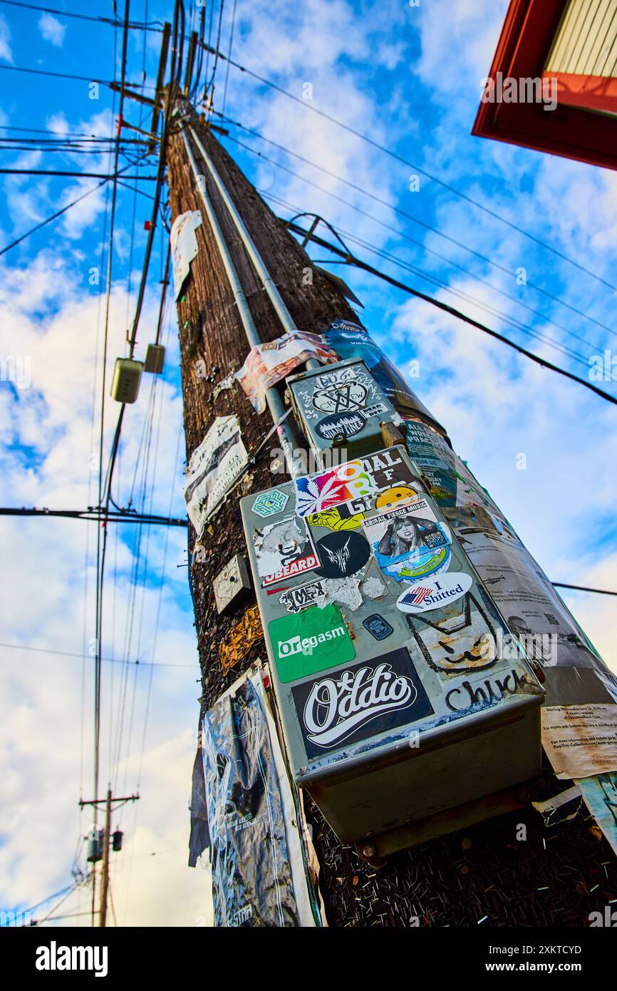 Urban Utility Pole with Stickers and Graffiti Against Blue Sky ...