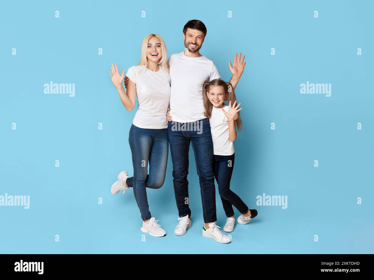 A happy family, including a man, woman, and young girl, all wearing ...