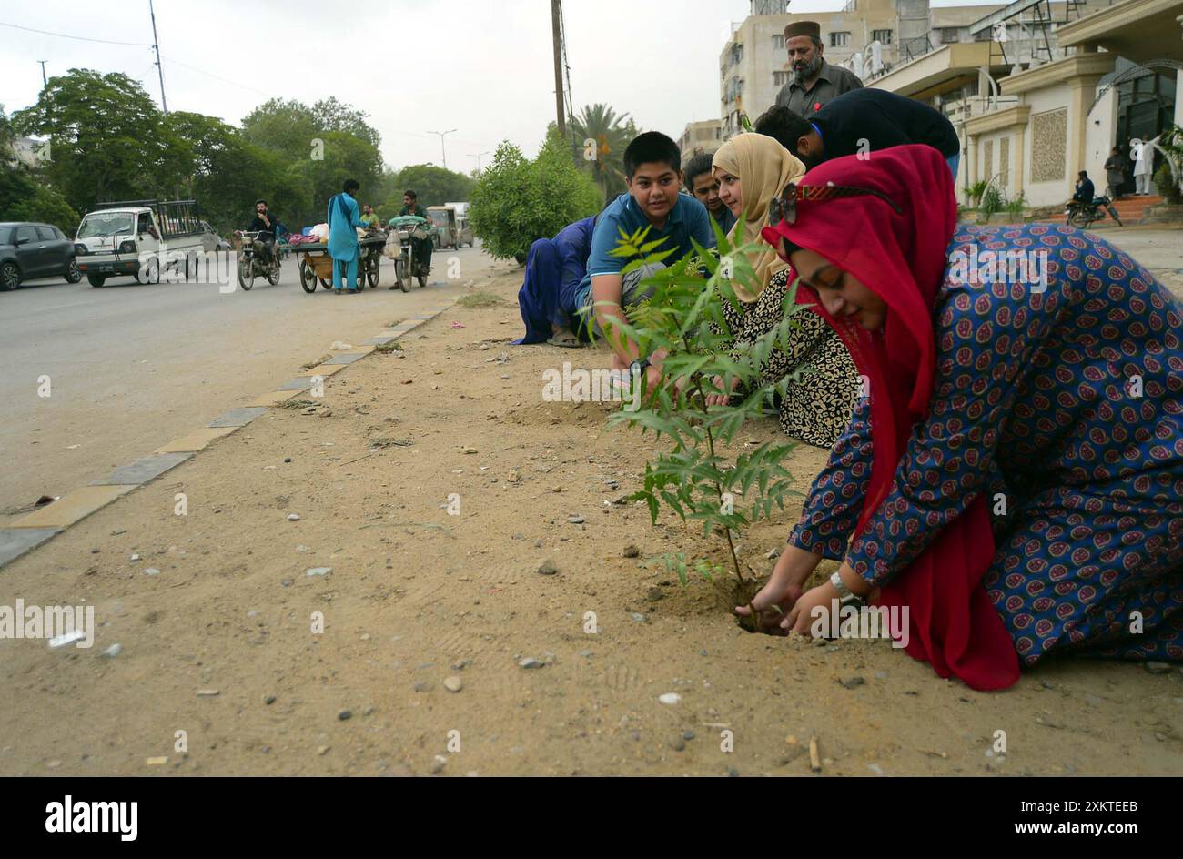 KARACHI, PAKISTAN, 24/07/2024, Participants are planting a sapling ...