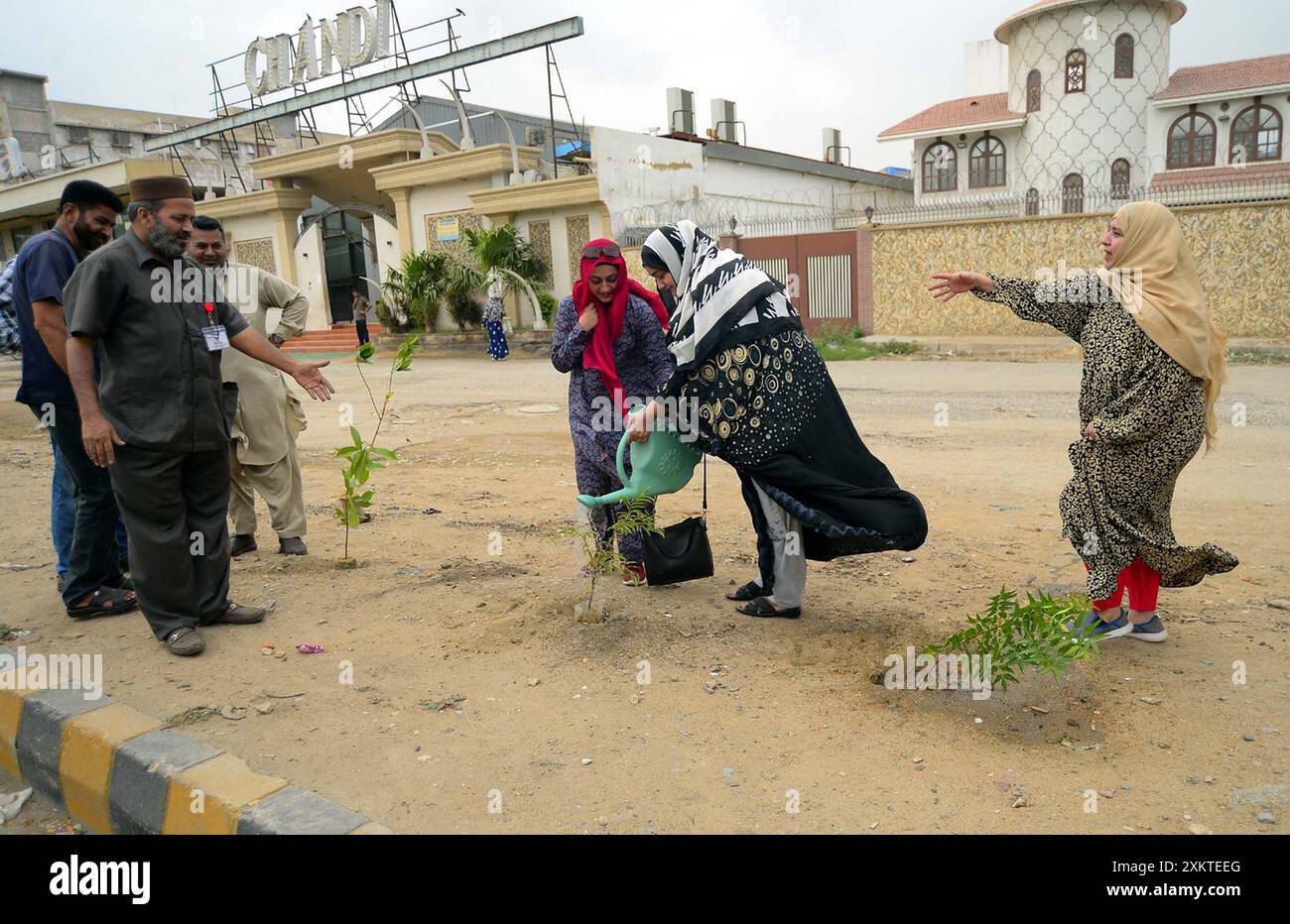 KARACHI, PAKISTAN, 24/07/2024, Participants are planting a sapling ...