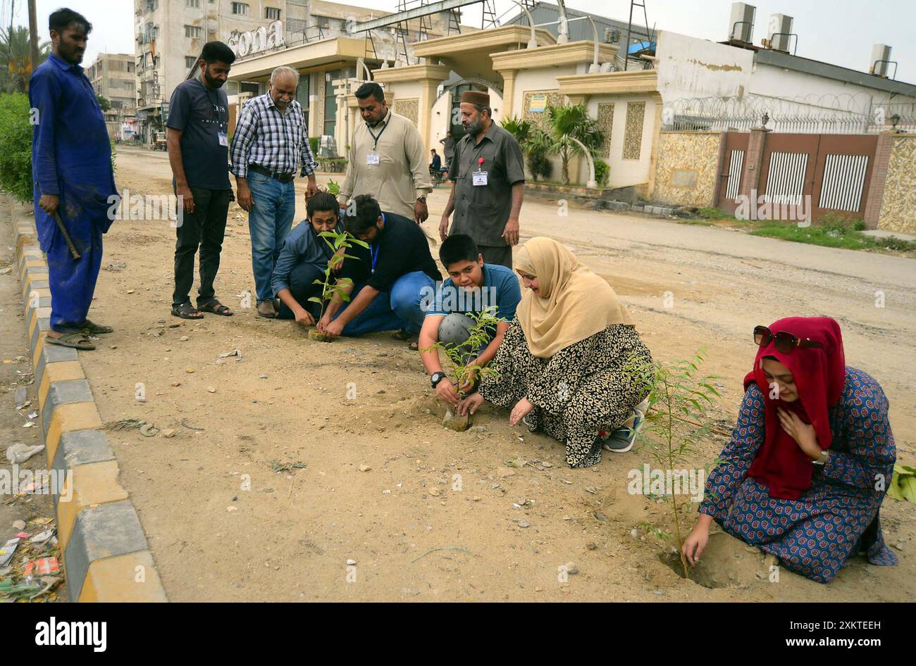 KARACHI, PAKISTAN, 24/07/2024, Participants are planting a sapling ...