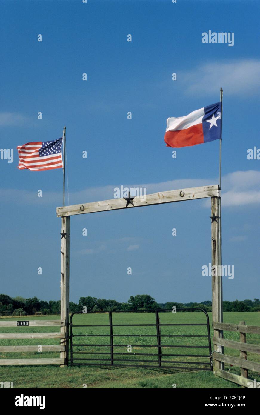 Timber ranch gate with TX and US flags on TX 90 highway near Anderson ...