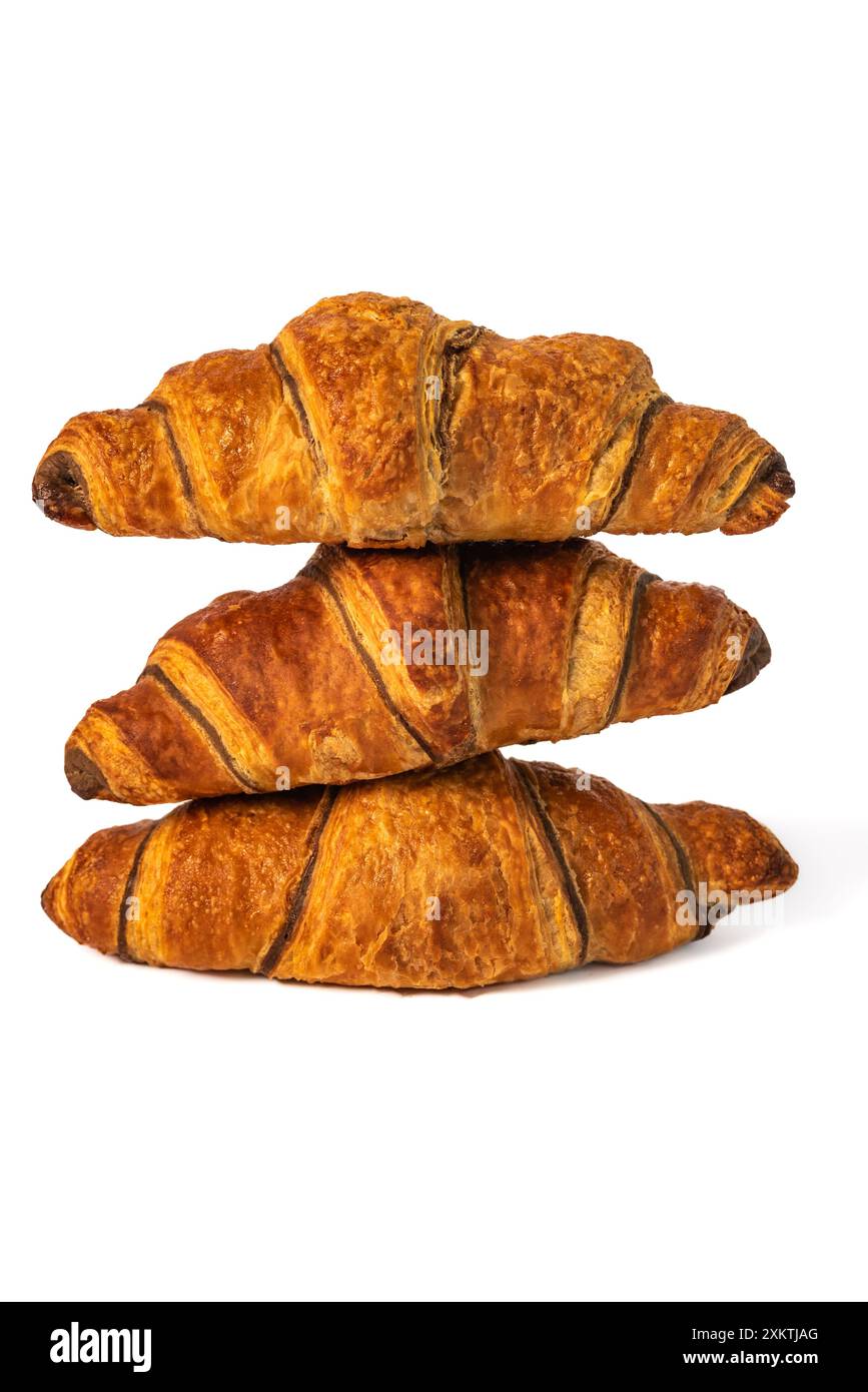 A trio of perfectly baked croissants, golden brown and flaky, are ...