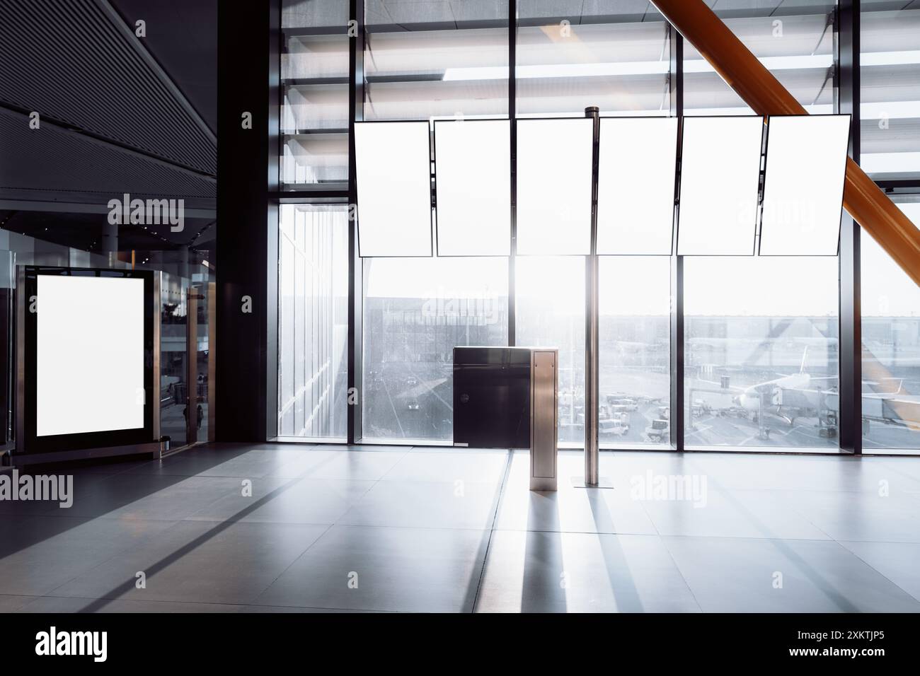 Mockup of blank displays and billboard on the left in a modern airport terminal with large ...
