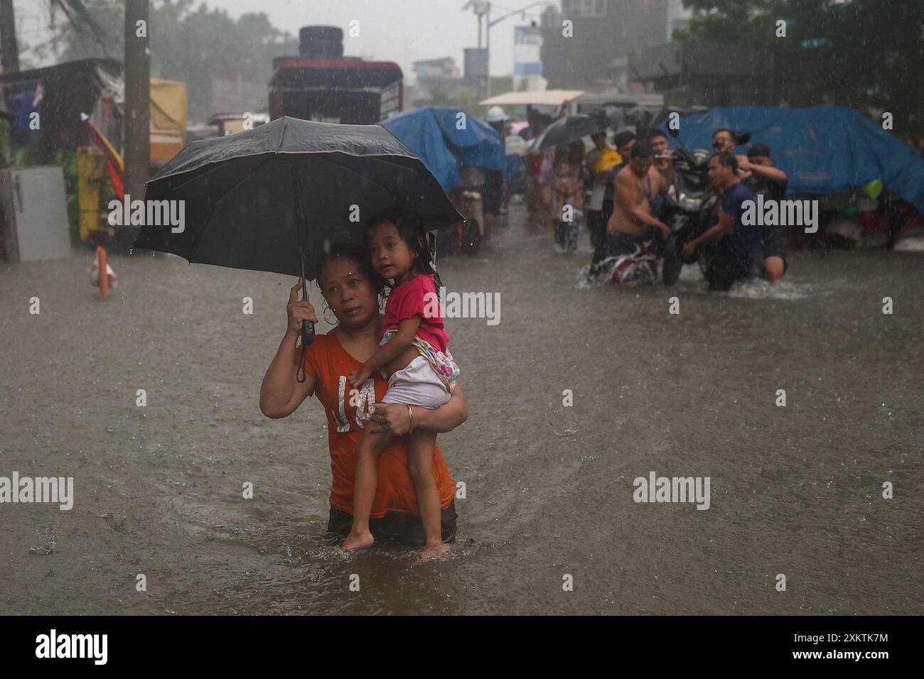 Quezon City, Metro Manila, Philippines. 24th July, 2024. People wade ...
