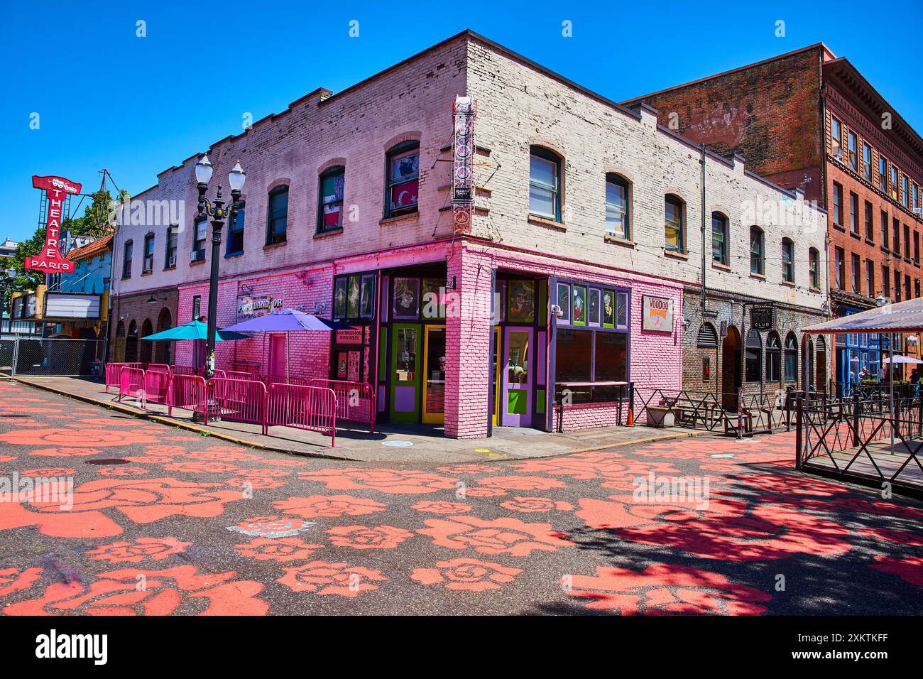 Lively Voodoo Doughnut with Pink Building and Colorful Brick Backdrop ...