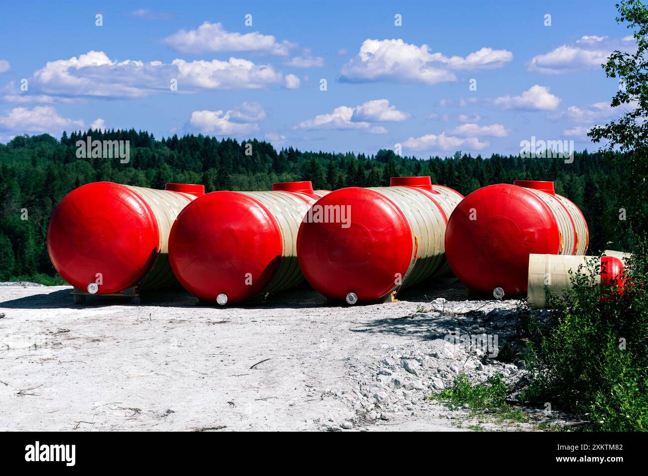 Four huge red tanks on a construction site in the forest of Karelia ...