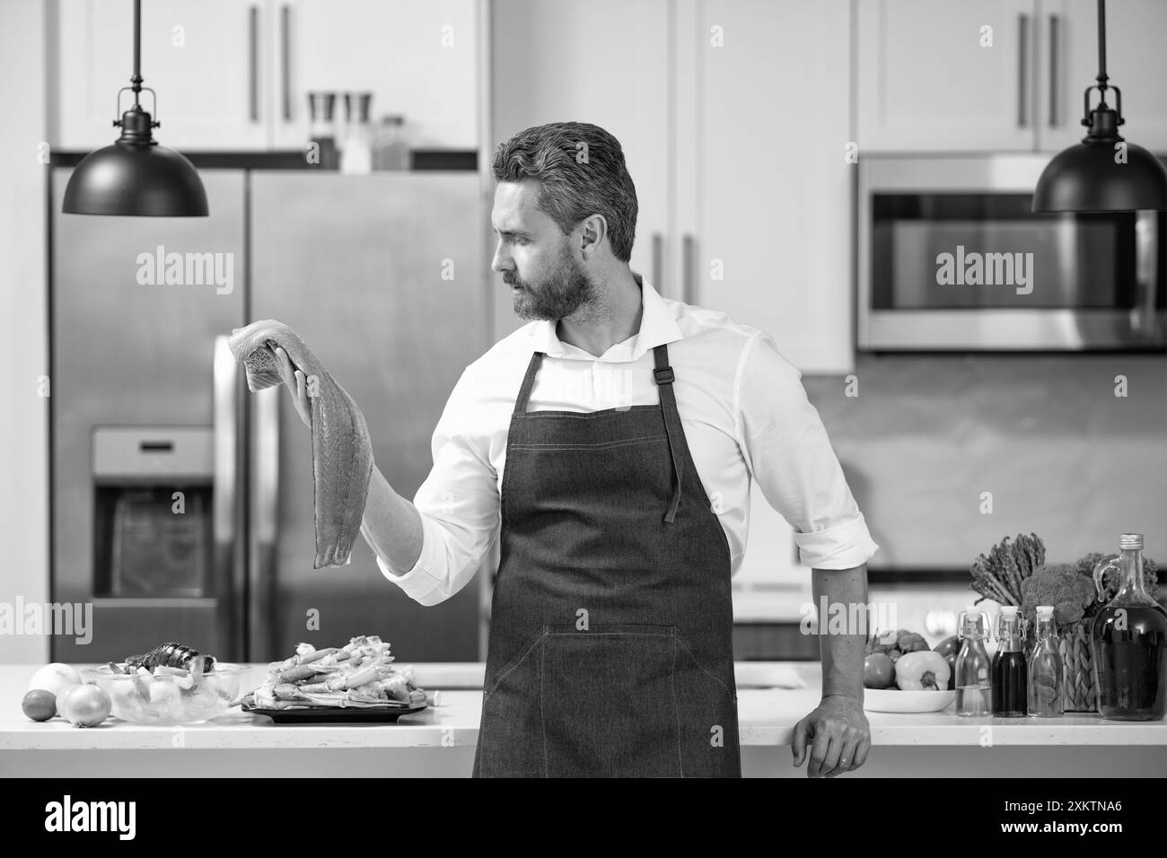 chef man cooking fish in the restaurant kitchen. photo of chef man ...