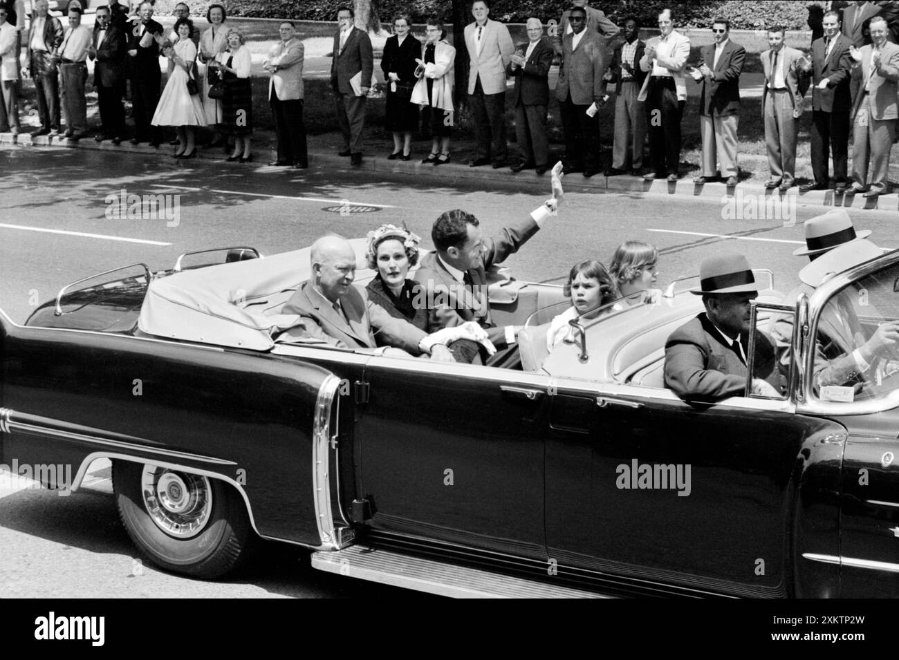 U.S. President Dwight Eisenhower riding in convertible car with U.S ...