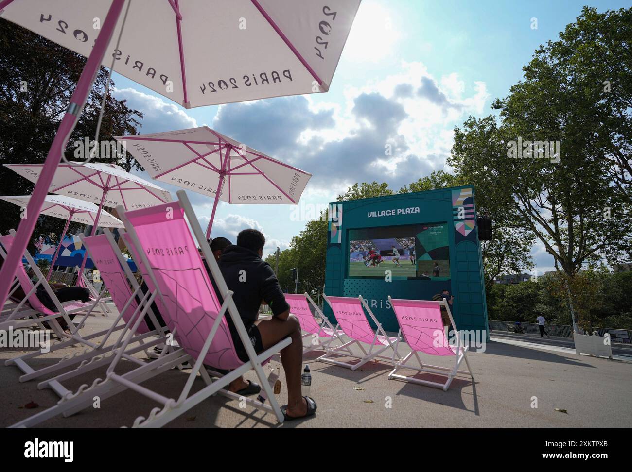 Athletes watch the men's Rugby Sevens Pool on a giant screen in the ...