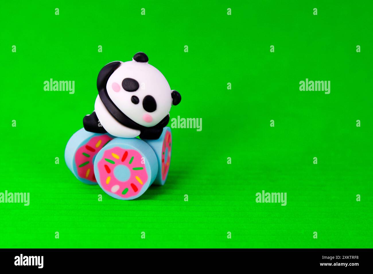 Panda bear exercising on colorful donuts Stock Photo - Alamy
