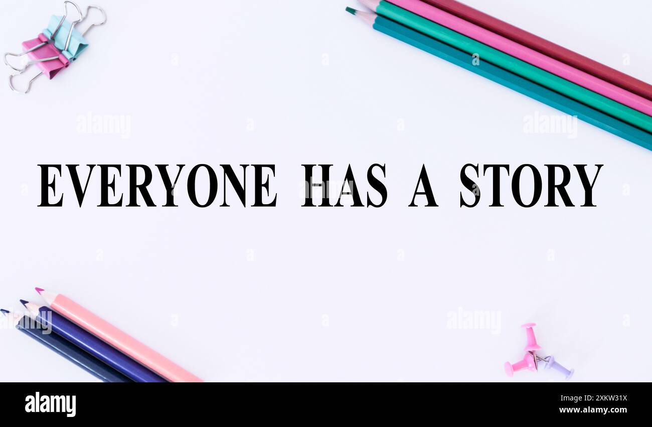 EVERYONE HAS A STORY text on white background and with pencils.The ...
