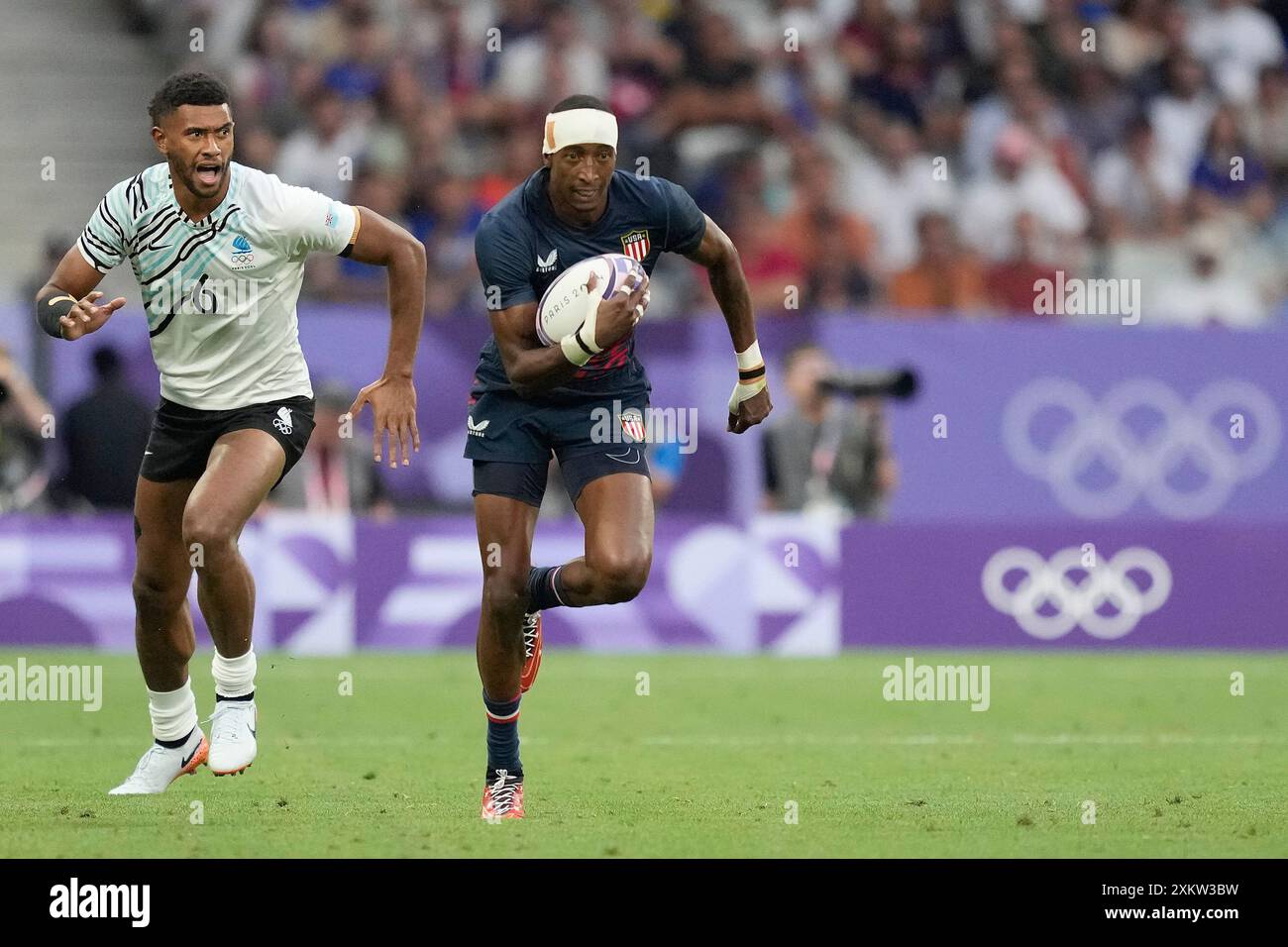 Fiji's Ponipate Loganimasi, left, reacts as United States' Perry Baker ...