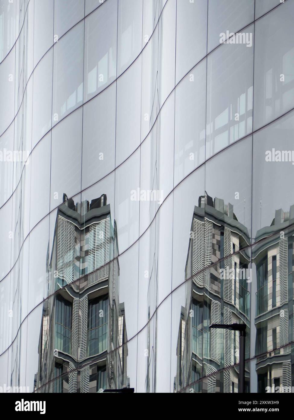Reflections in a glass window office building sharing modern ...
