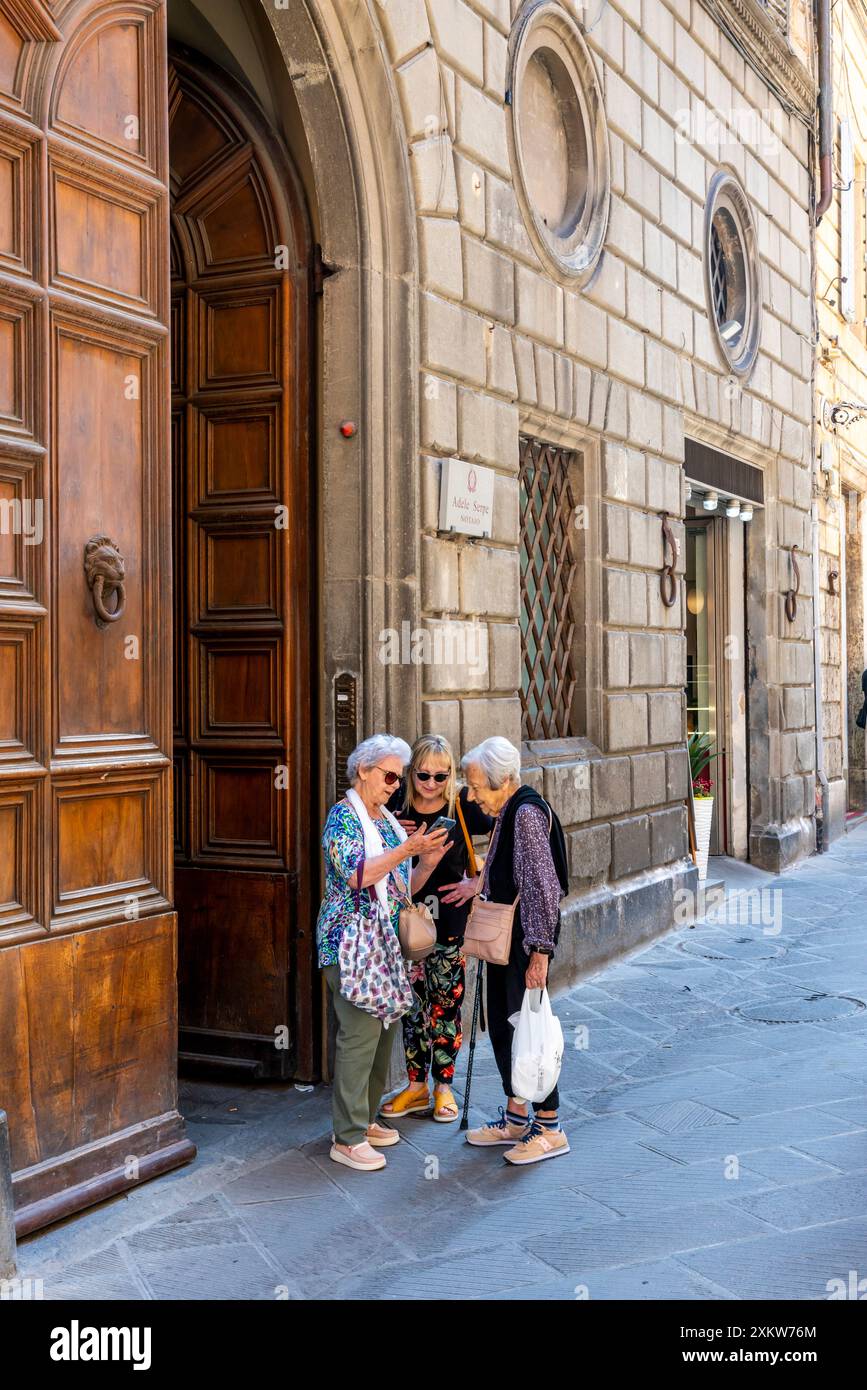 A Group Of Local Women Chatting In A Street In Siena, Tuscany, Italy ...