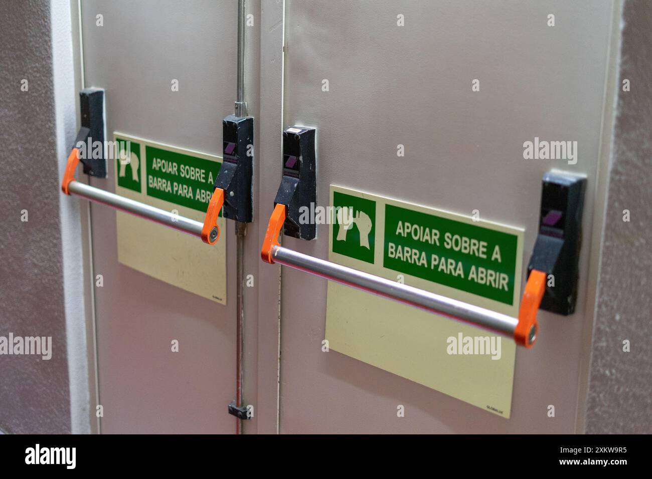 Emergency exit door panic bars with signage Stock Photo - Alamy