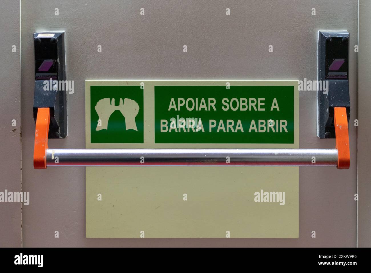 Emergency exit door panic bars with signage Stock Photo - Alamy