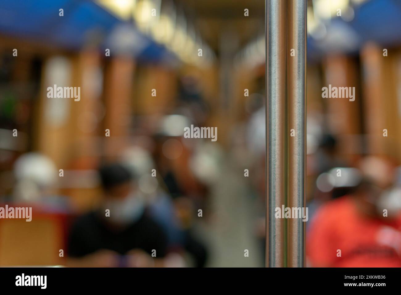 Hand grip or rod to hold passengers in subway car on blurred background ...