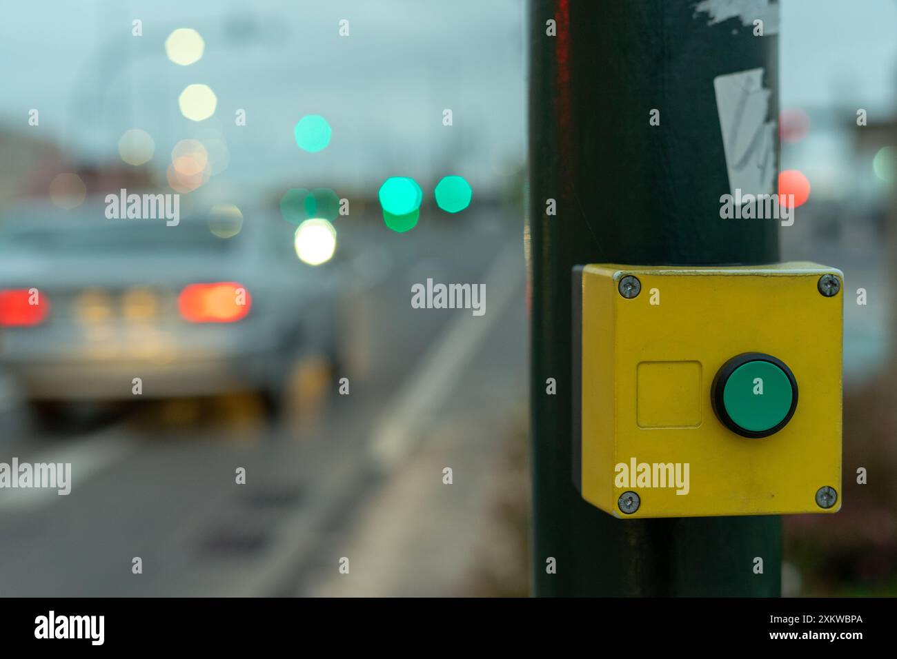 Green button with yellow frame to stop traffic on crosswalk with ...