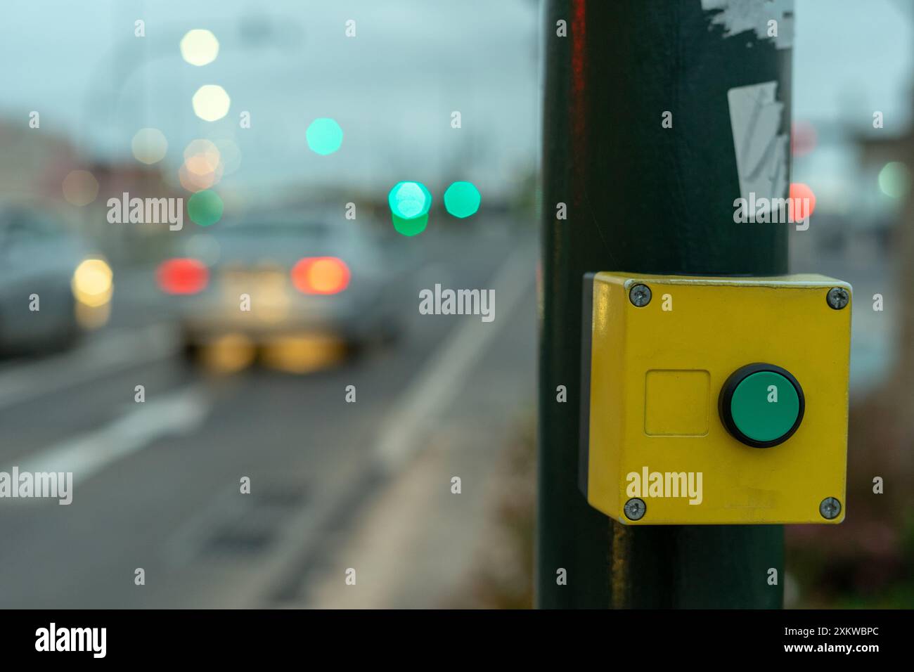 Green button with yellow frame to stop traffic on crosswalk with ...