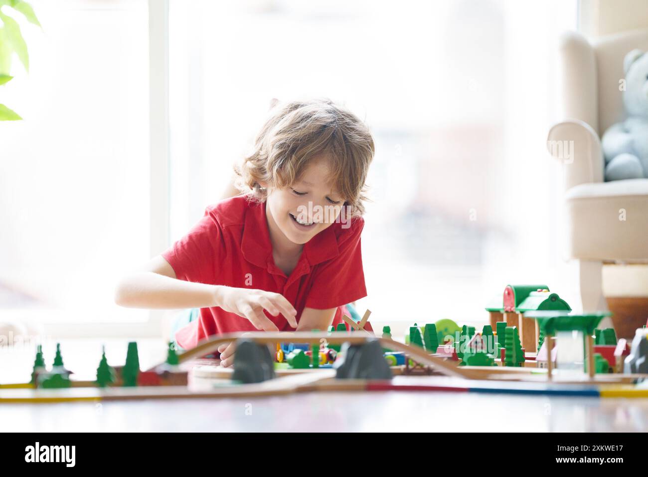 Kids play with wooden railway. Child with toy train. Educational toys ...