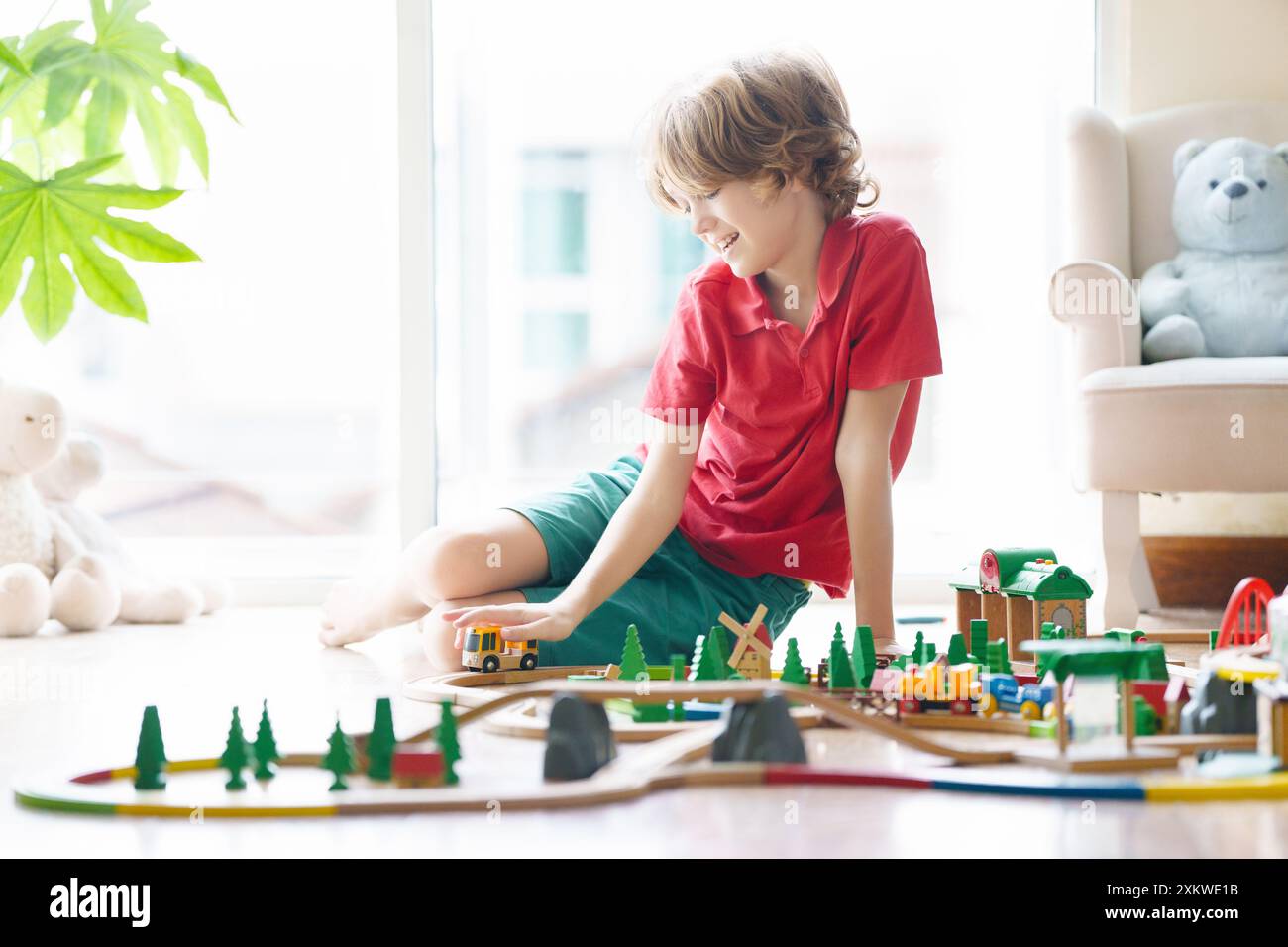 Kids play with wooden railway. Child with toy train. Educational toys ...