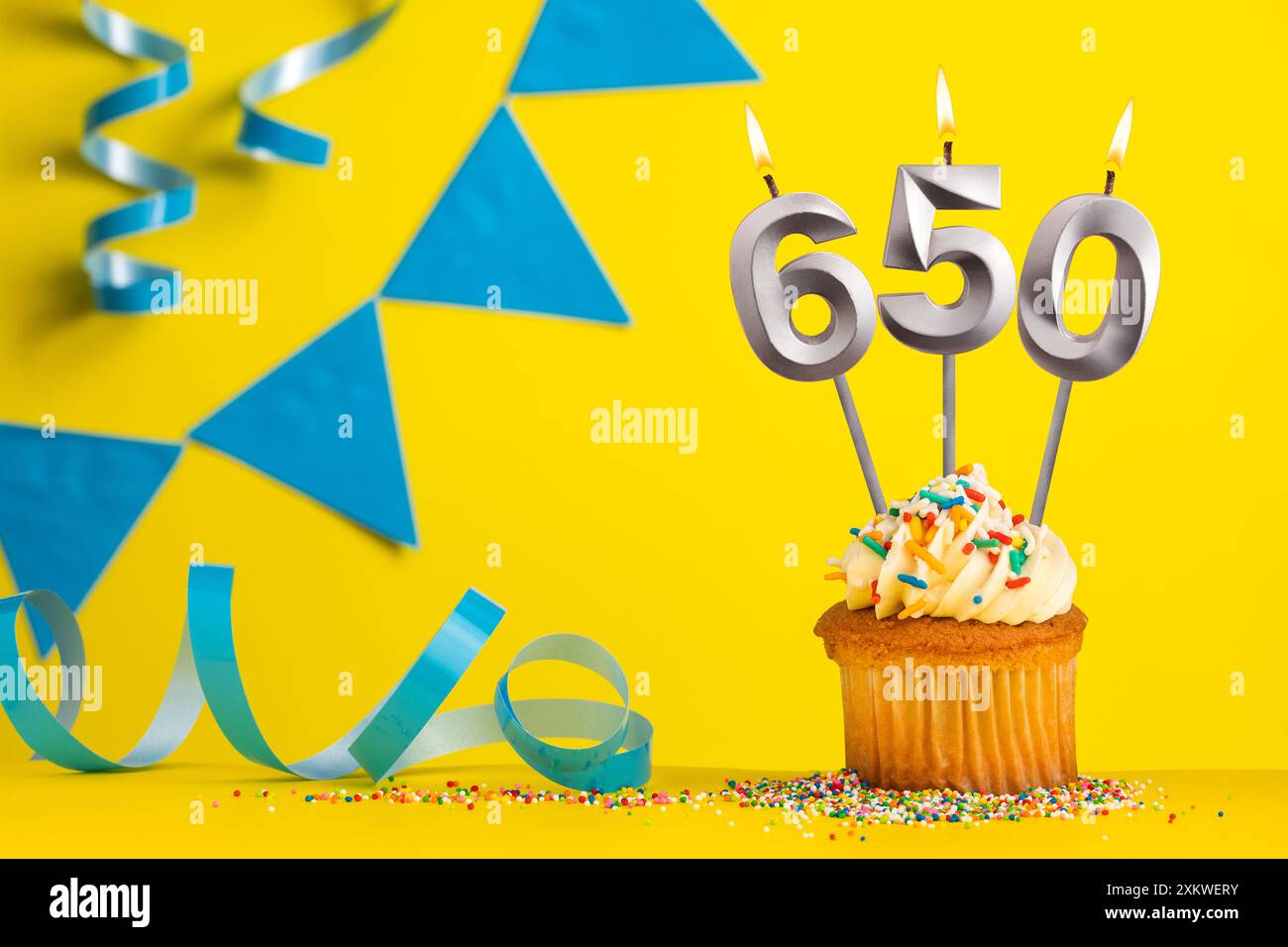 Birthday candle number 650 with cupcake - Yellow background with blue ...