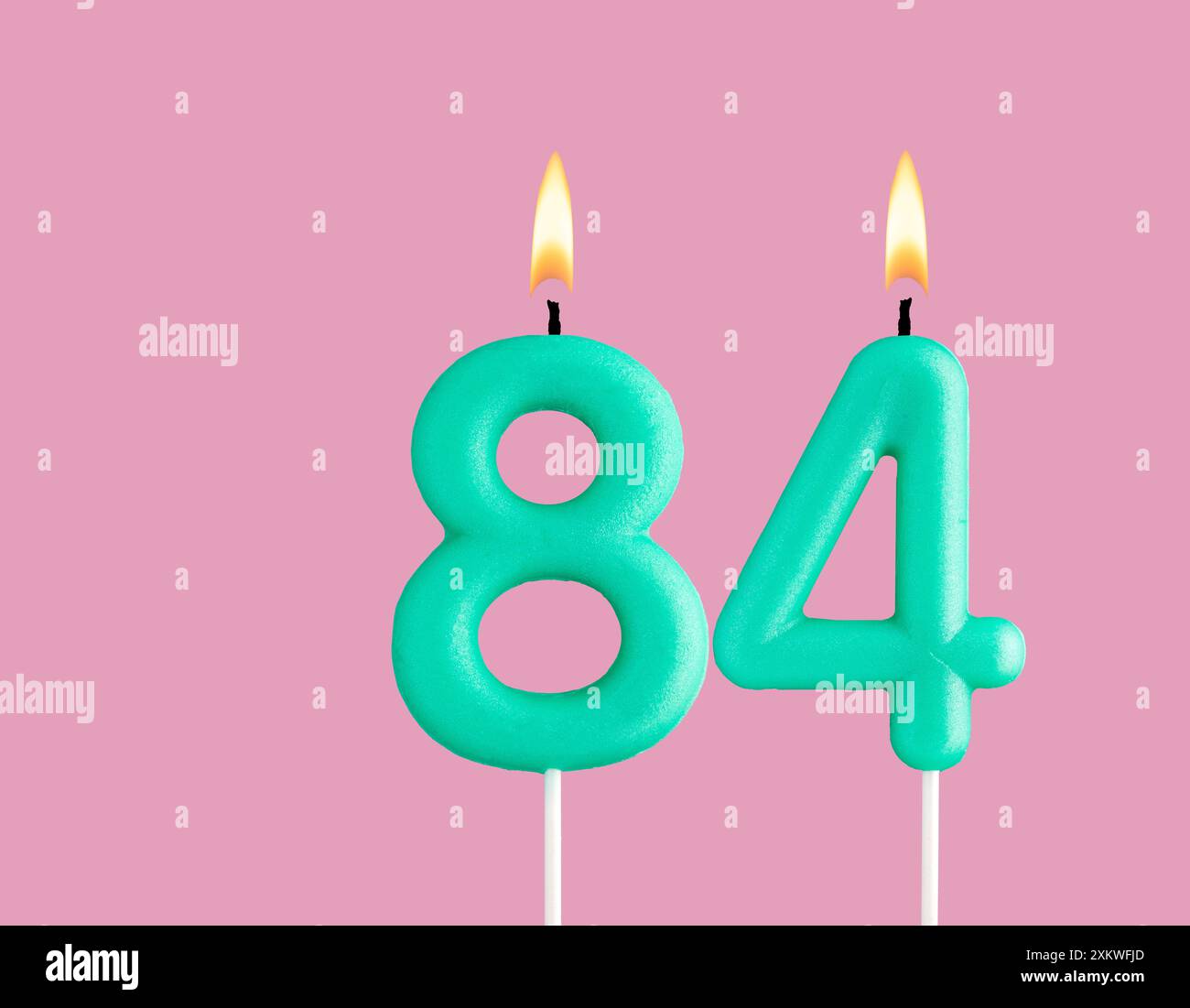 Green candle number 84 - Birthday card on pastel pink background Stock ...
